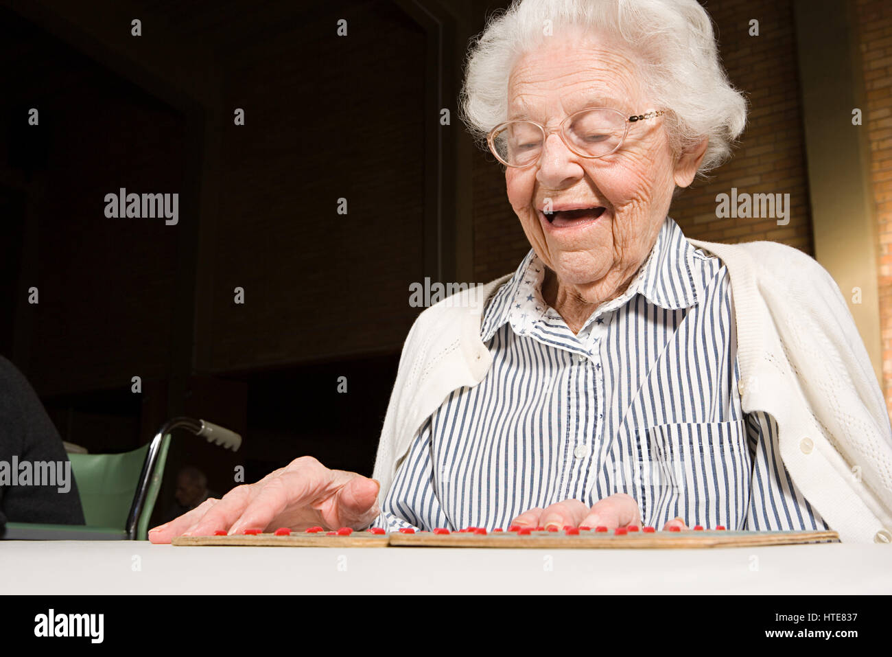 Senior woman playing bingo Stock Photo - Alamy