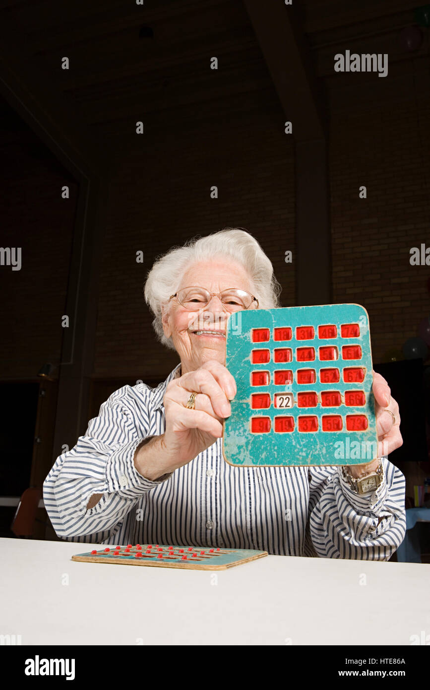 Senior woman playing bingo Stock Photo - Alamy