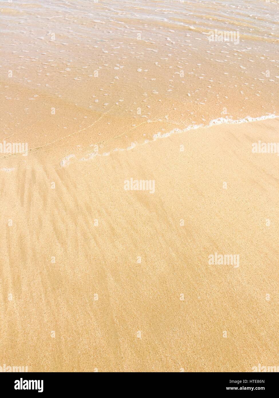 Sea waves reaching lapping to shore Stock Photo - Alamy