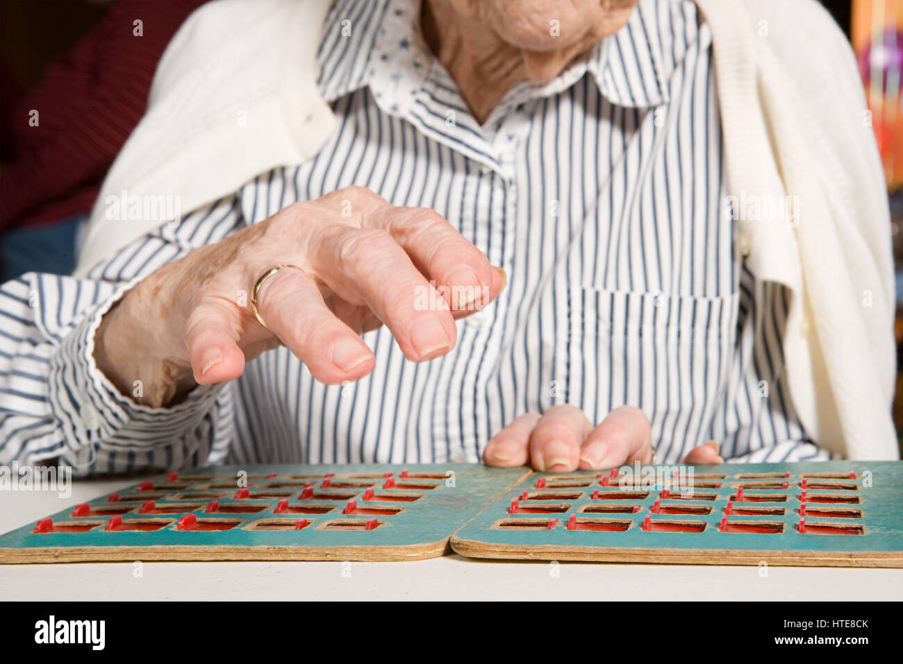Senior woman playing bingo Stock Photo - Alamy