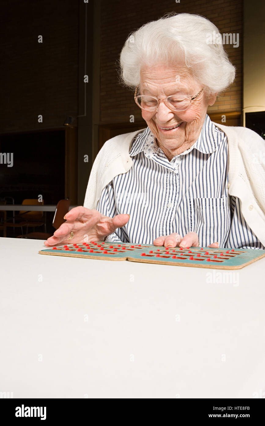 Senior woman playing bingo Stock Photo - Alamy