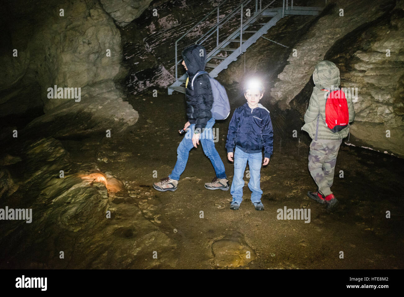 Children explore underground cavern Stock Photo - Alamy