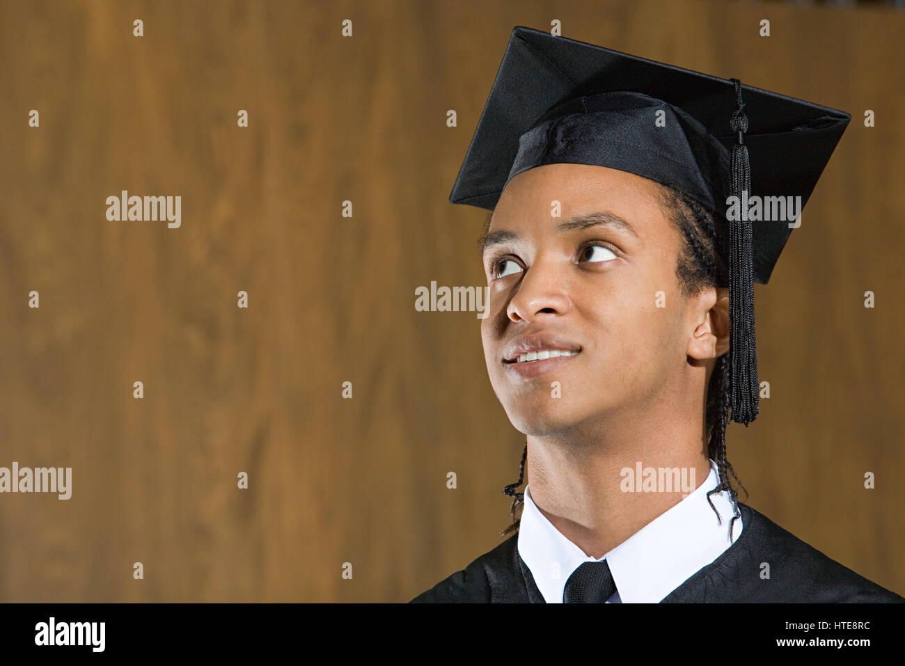 Male graduate looking up Stock Photo - Alamy