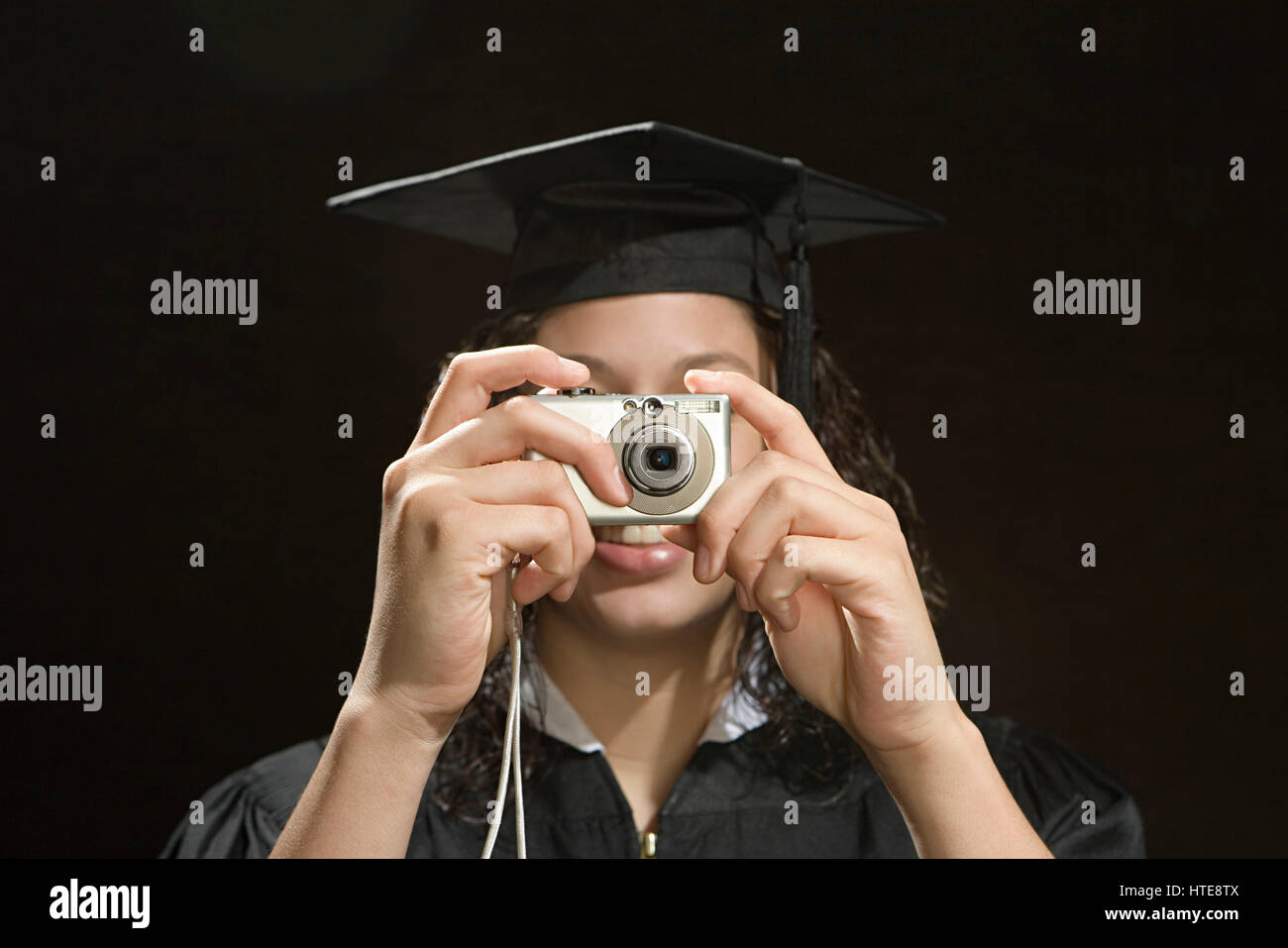 Female graduate taking a photograph Stock Photo - Alamy