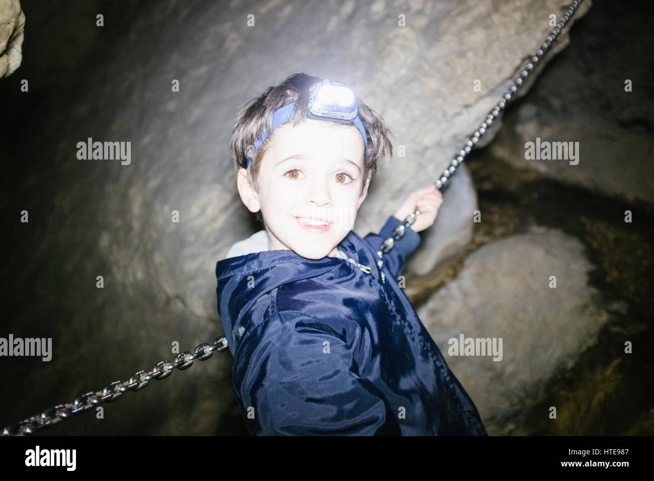 Children explore underground cavern Stock Photo - Alamy