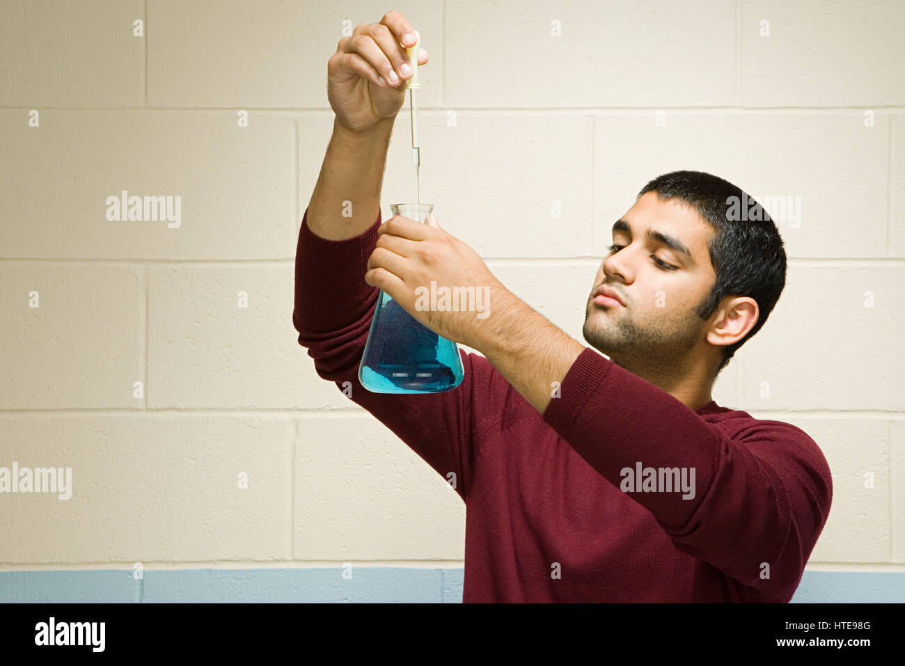 Male student performing an experiment Stock Photo - Alamy