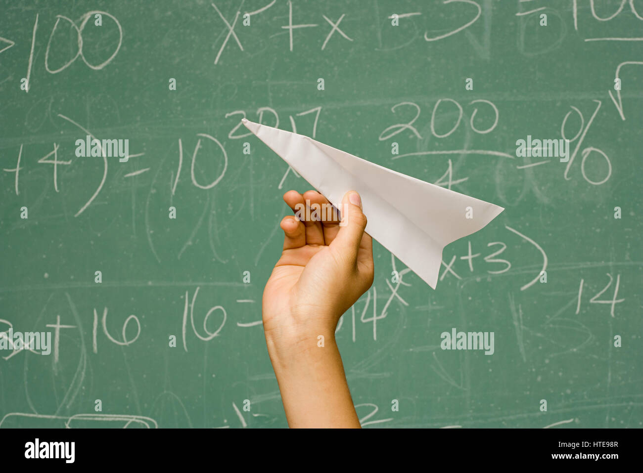 Student about to throw paper aeroplane Stock Photo - Alamy
