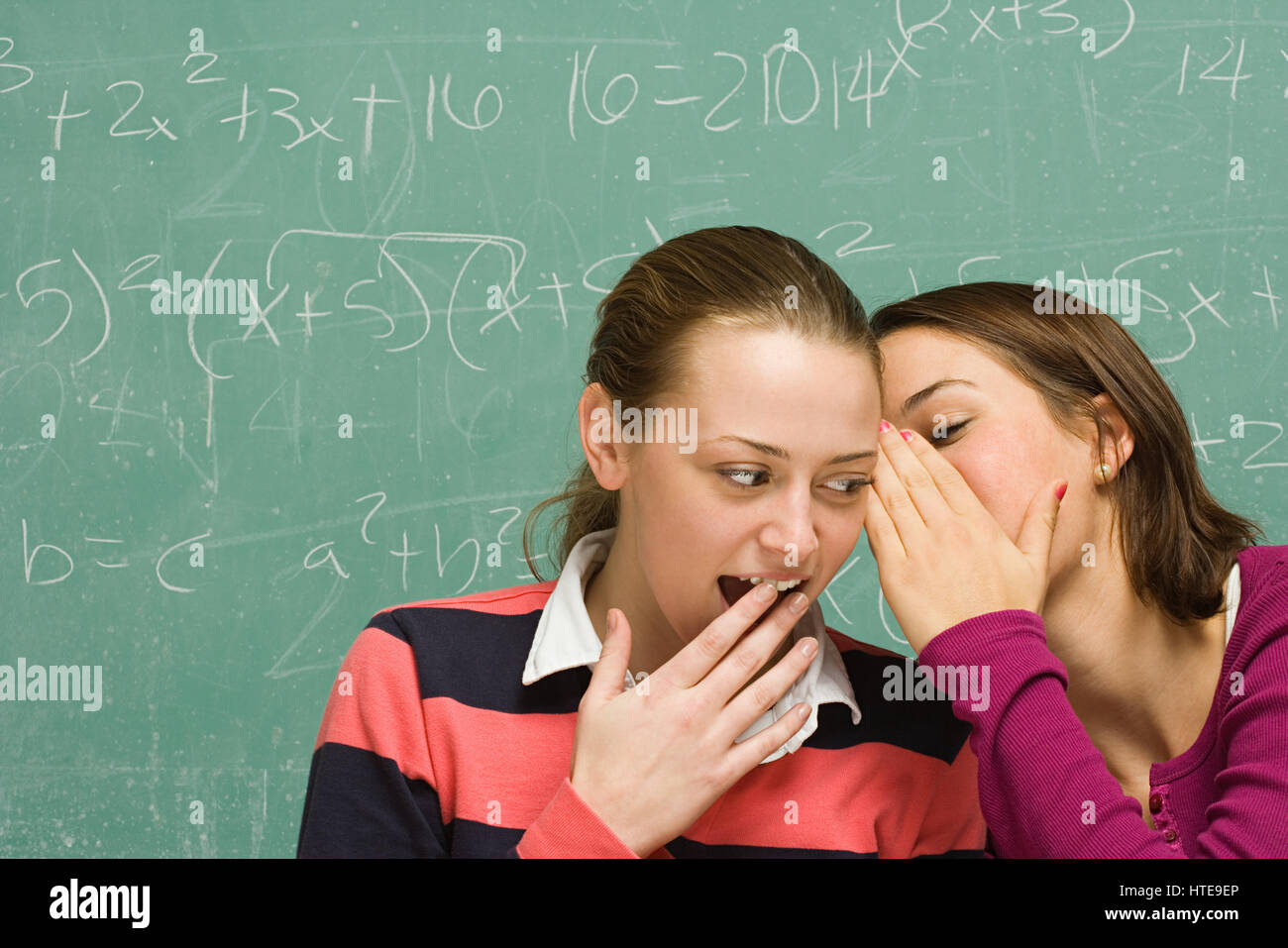 Two female students sharing a secret Stock Photo - Alamy