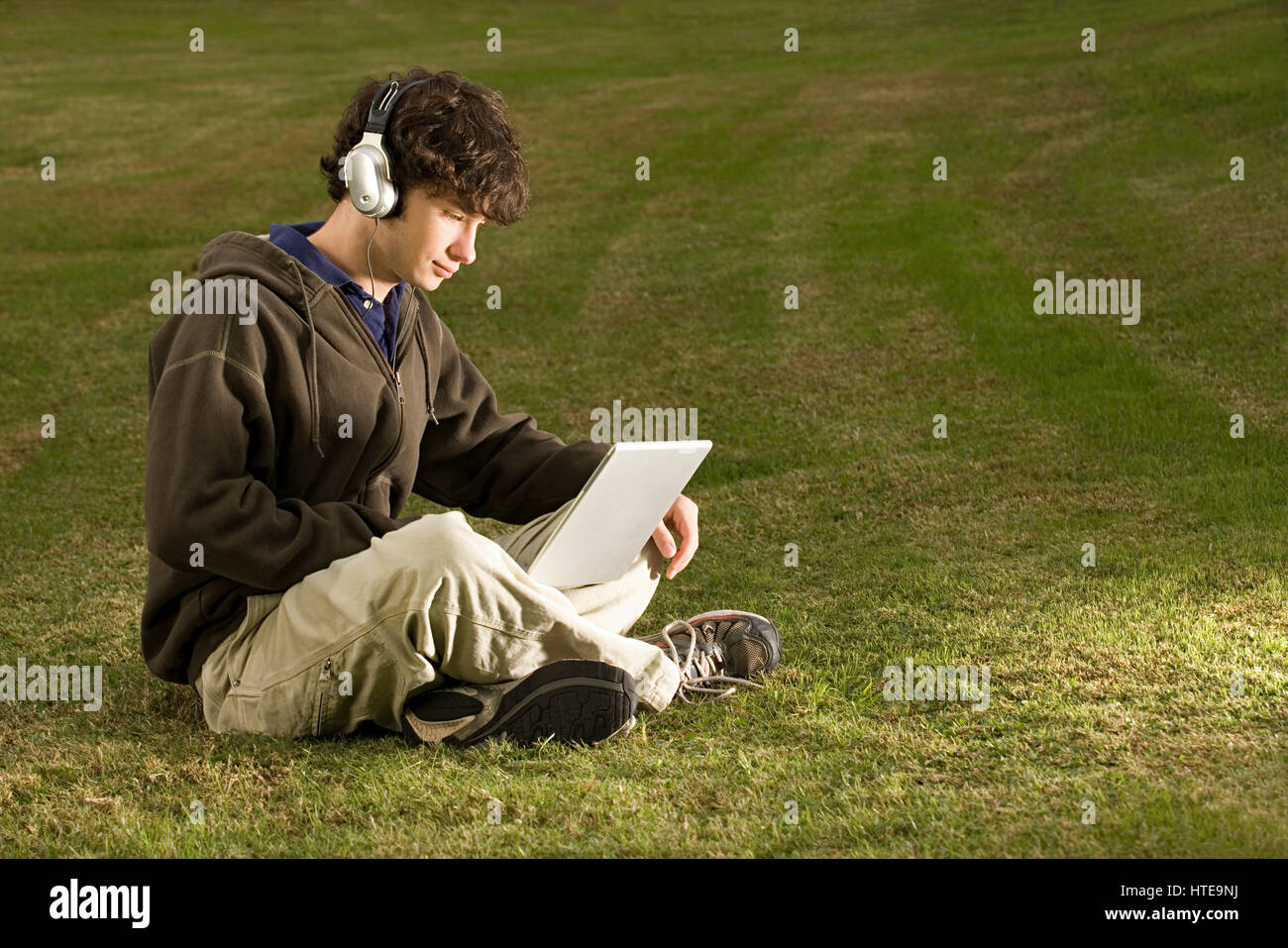 Male student using a laptop computer outdoors Stock Photo - Alamy