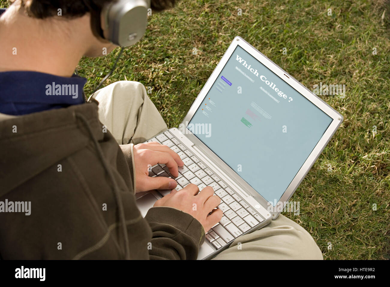 Male student using a laptop outdoors Stock Photo - Alamy