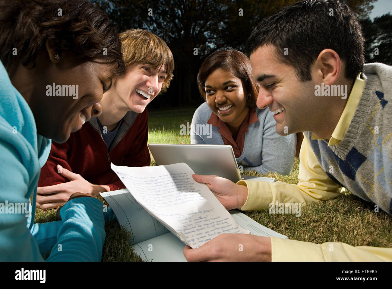 Four students studying outdoors Stock Photo - Alamy