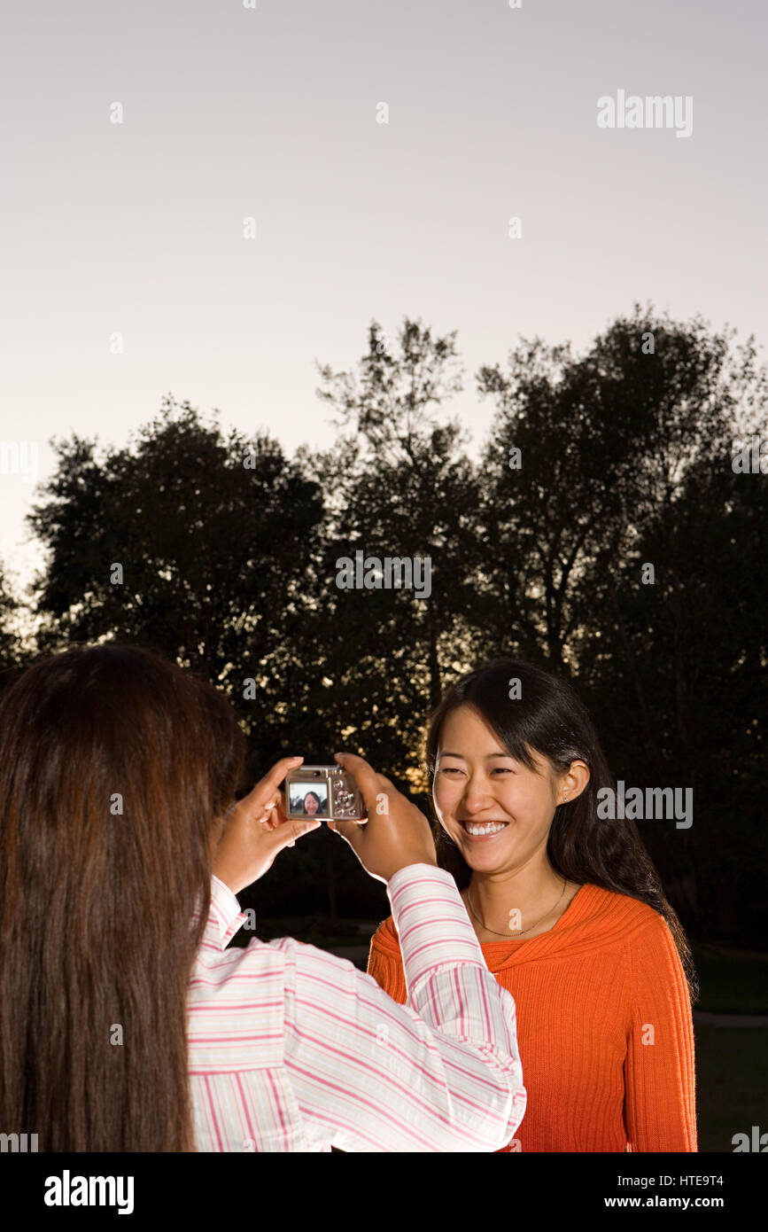 Two friends taking a photograph Stock Photo - Alamy