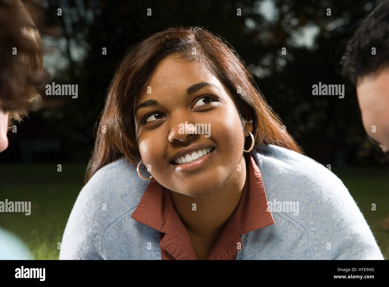 Three students studying outdoors Stock Photo - Alamy