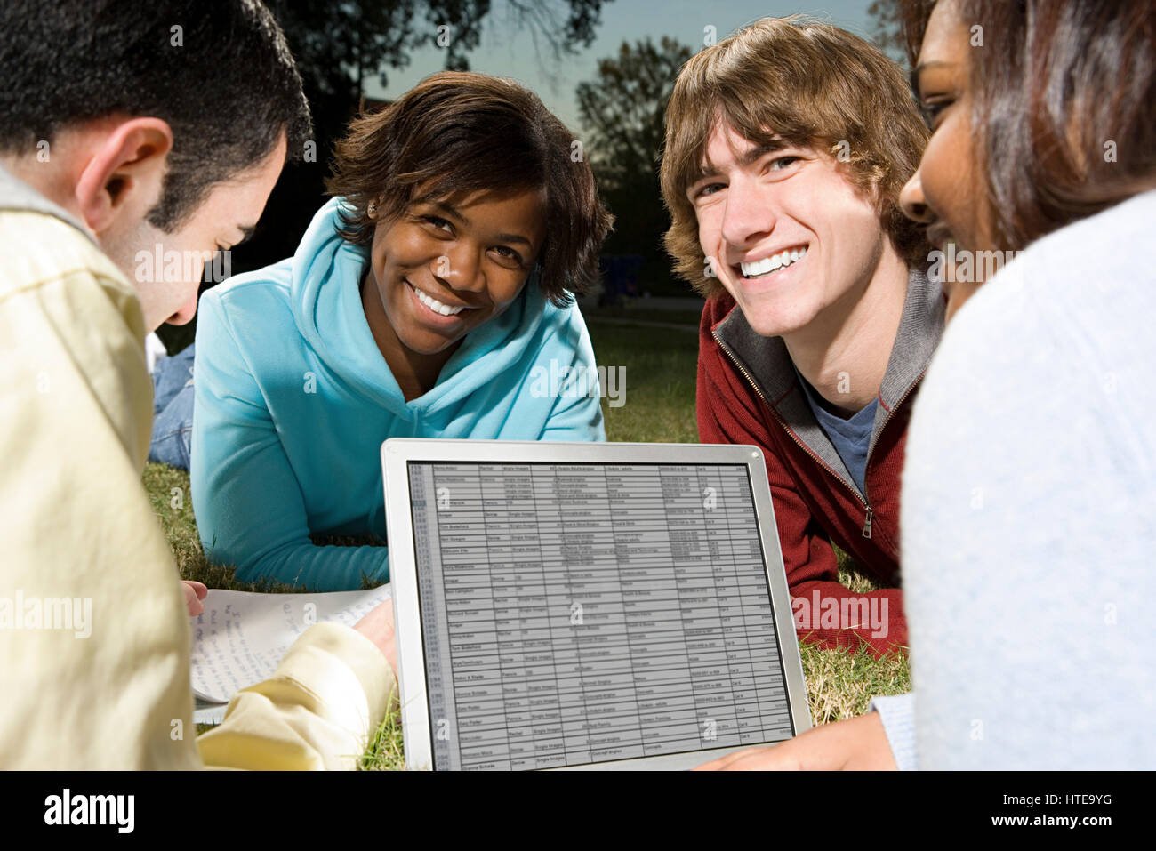Four students studying outdoors Stock Photo - Alamy