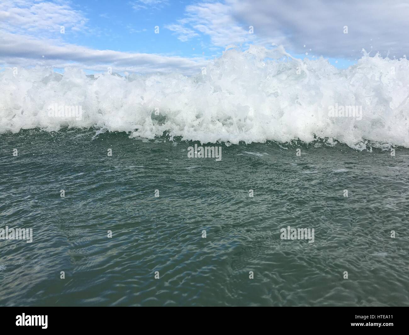 Sea waves reaching lapping to shore Stock Photo - Alamy