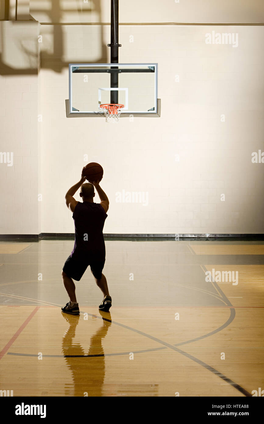 Man aiming for basketball hoop Stock Photo - Alamy