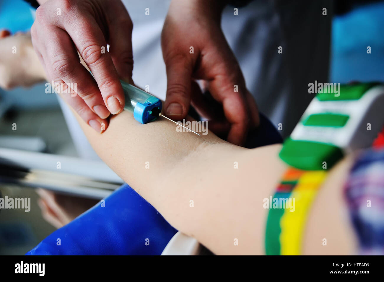 Doctor making blood analysis young girl patient. Blood sampling from a ...