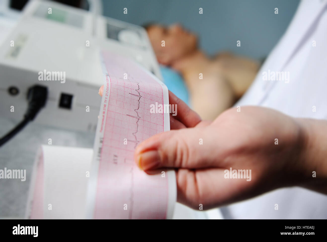 Electrocardiogram, ECG in hand. Clinic of Cardiology heart rate and ...