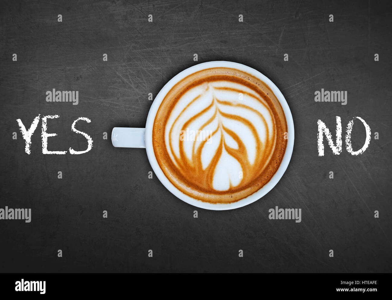 Cup of coffee on black board switching yes Stock Photo - Alamy