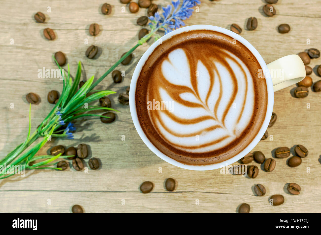 Cup of espresso hot drink with coffee beam on wooden table Stock Photo ...