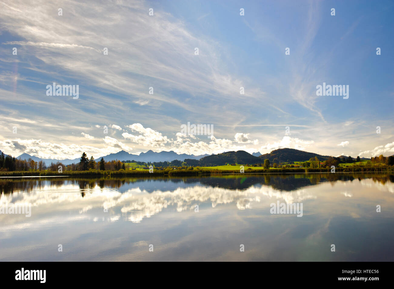 Panorama scene in Bavaria with mountains mirroring in lake Stock Photo ...