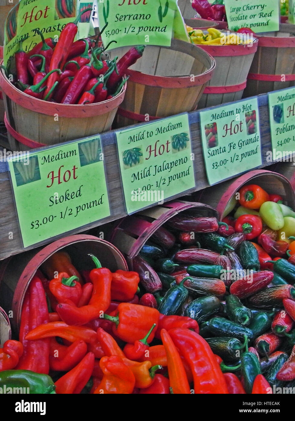 Different types of chili and peppers on a market Stock Photo - Alamy