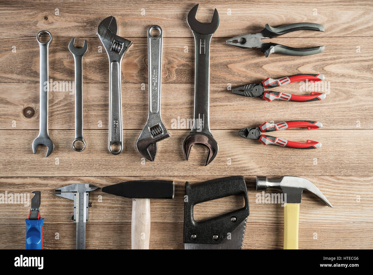 Variety of repair tools on wooden surface Stock Photo - Alamy