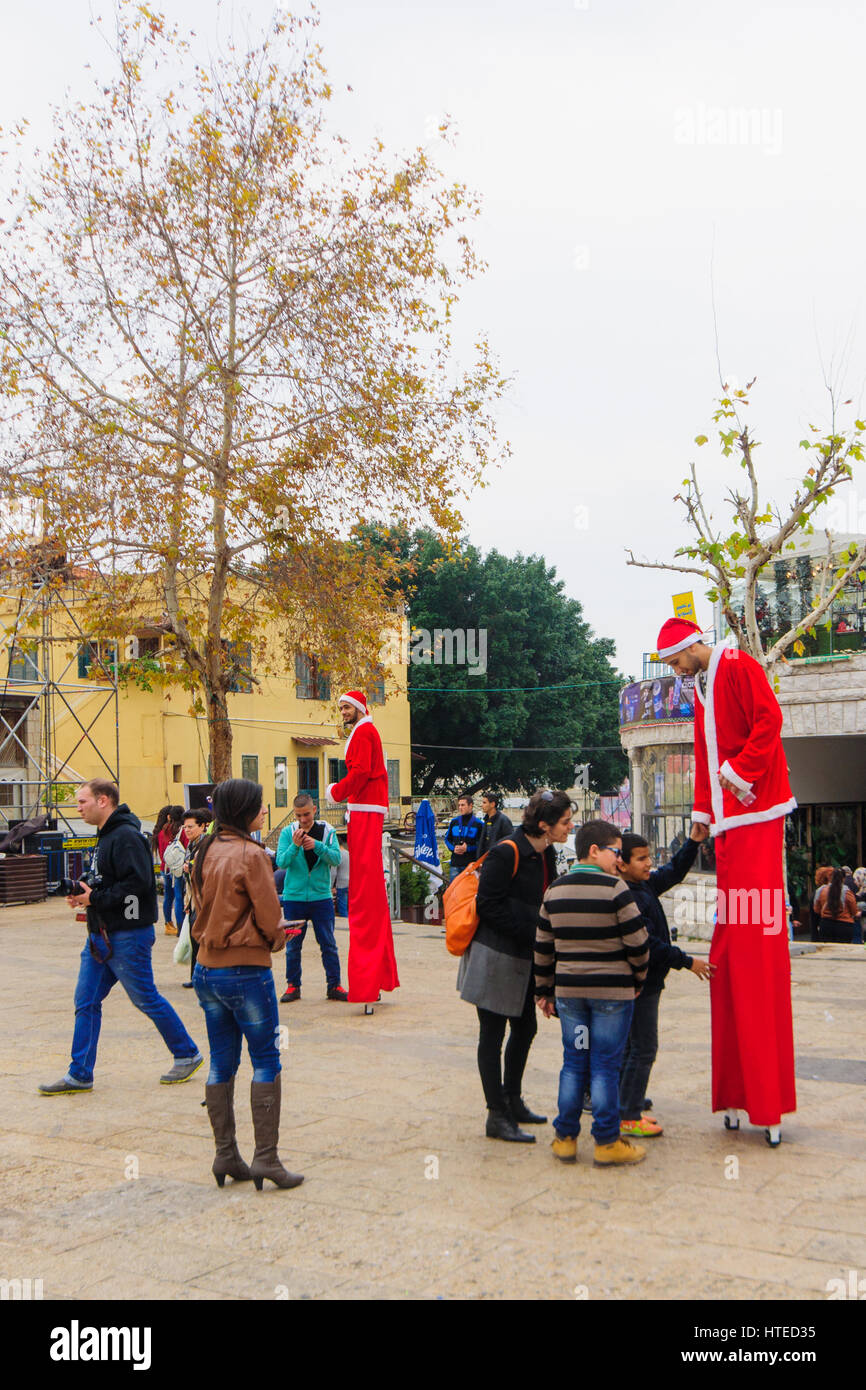 NAZARETH, ISRAEL - December 19, 2014: Santa Claus figures on stilts ...