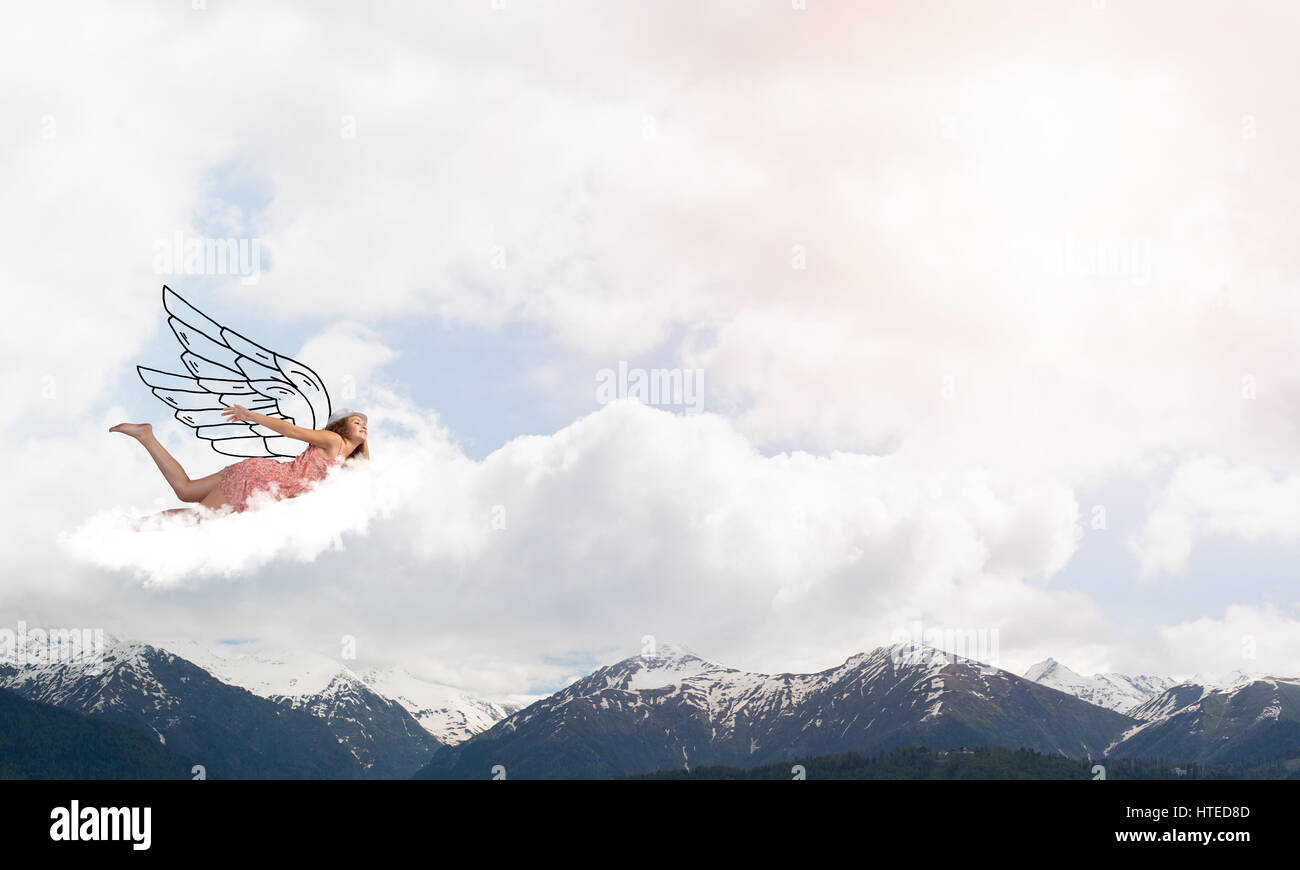 Young woman flying high in blue sky Stock Photo - Alamy