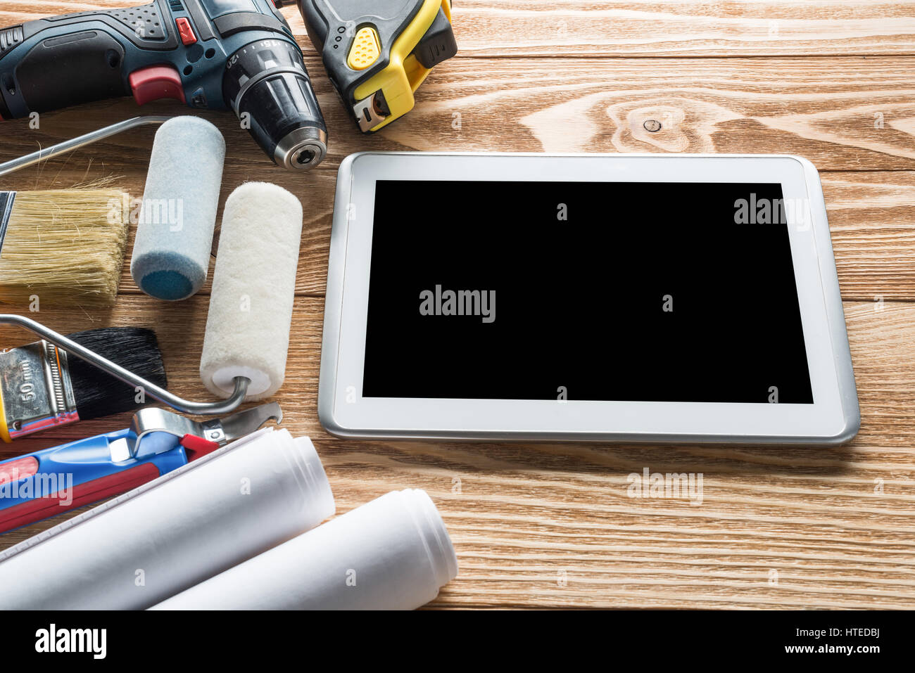 Variety of tools of builder and tablet pc on wooden texture table Stock ...