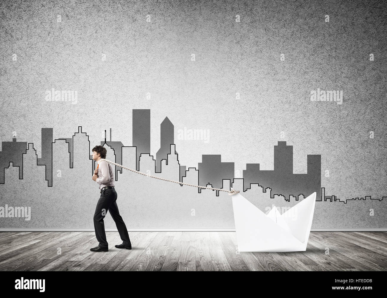 Successful businessman pulling with rope paper boat Stock Photo - Alamy