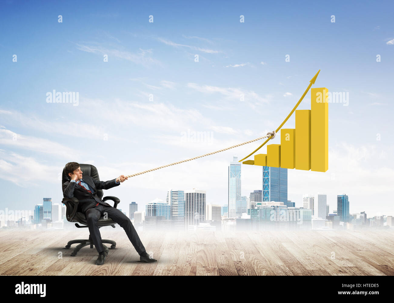 Young businessman outdoors making huge graph move Stock Photo - Alamy