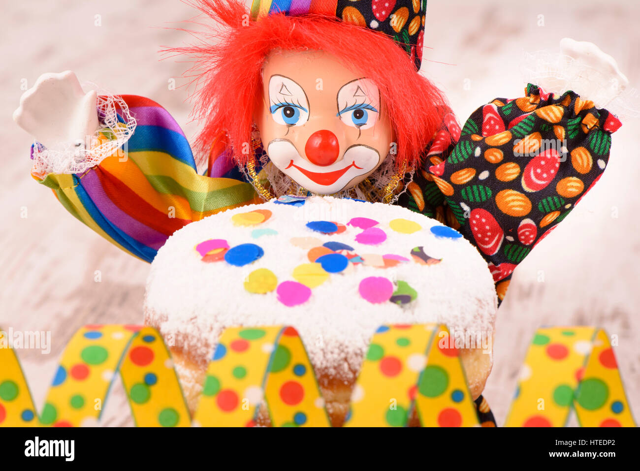 clown with red hairs and sweet donut at carnival Stock Photo - Alamy