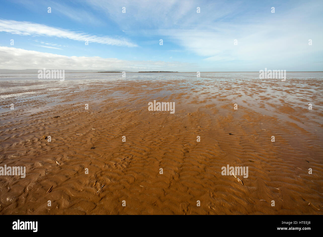 Red rocks beach at Hoylake on The Wirral, looking across the sands to ...