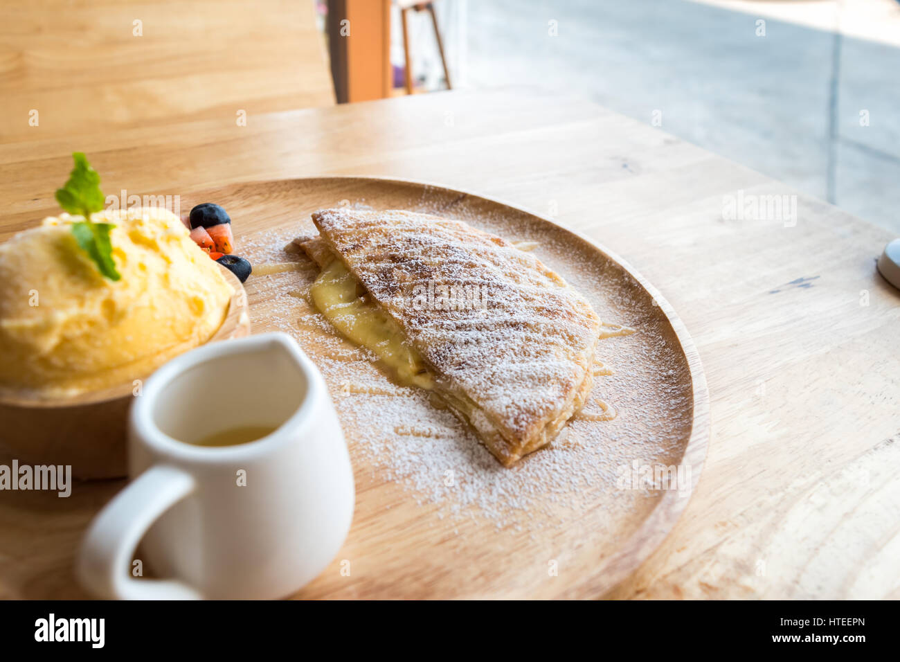 fresh dessert soft vanila roti with ice cream ,syrup ,strawberry and ...