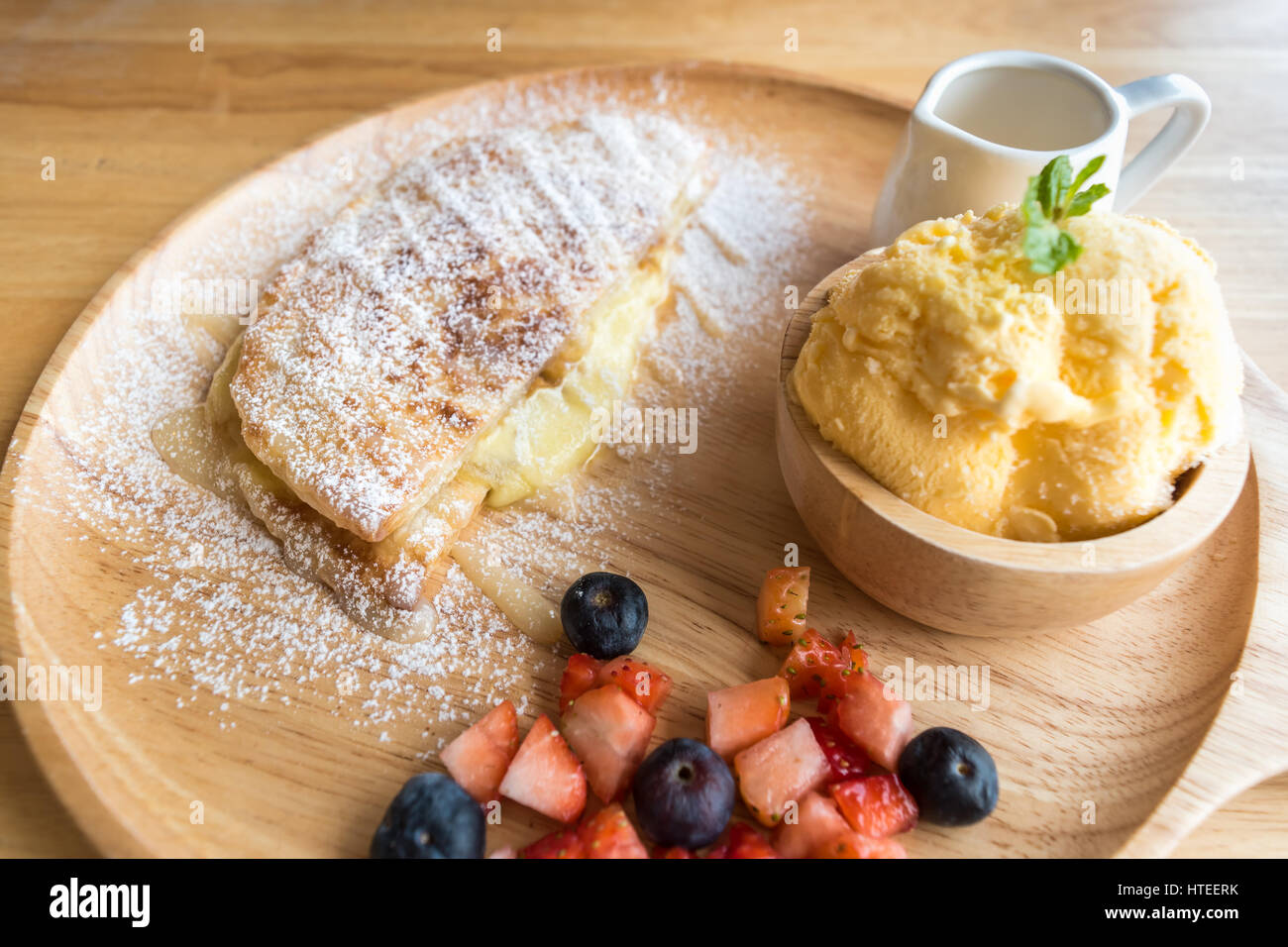 fresh dessert soft vanila roti with ice cream ,syrup ,strawberry and ...