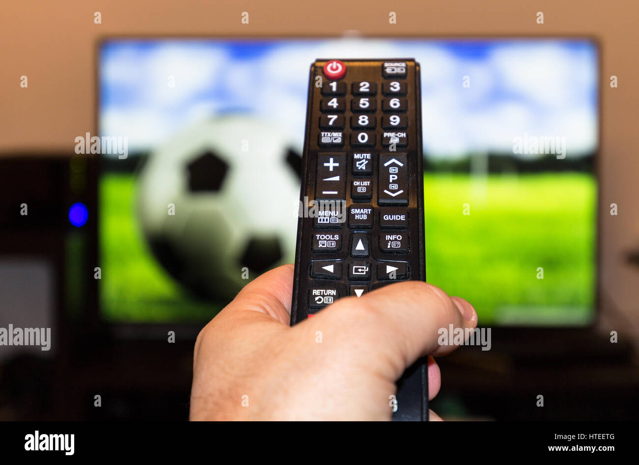 Football match and remote control Stock Photo - Alamy