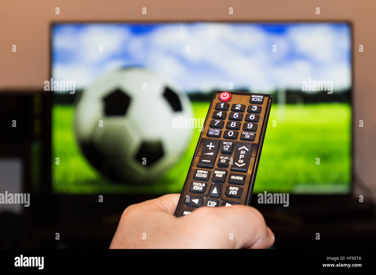Football match and remote control Stock Photo - Alamy