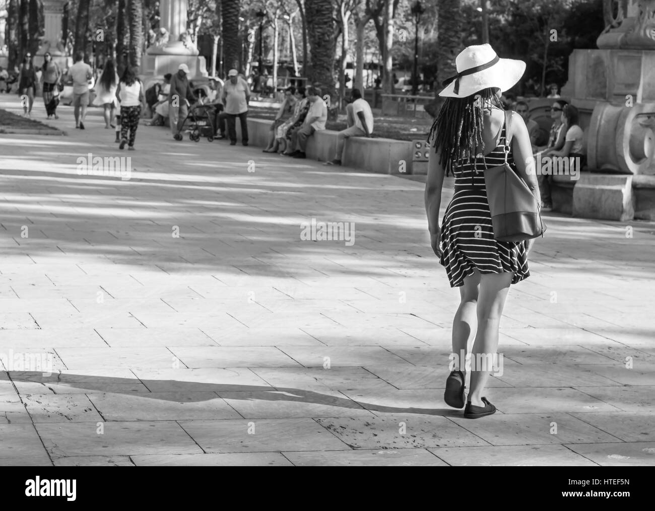 Woman walking on sunshine Stock Photo - Alamy
