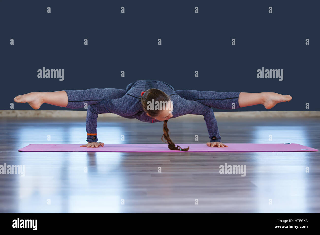 Young slim woman in yoga hole making beautiful asana exercises. Healthy ...