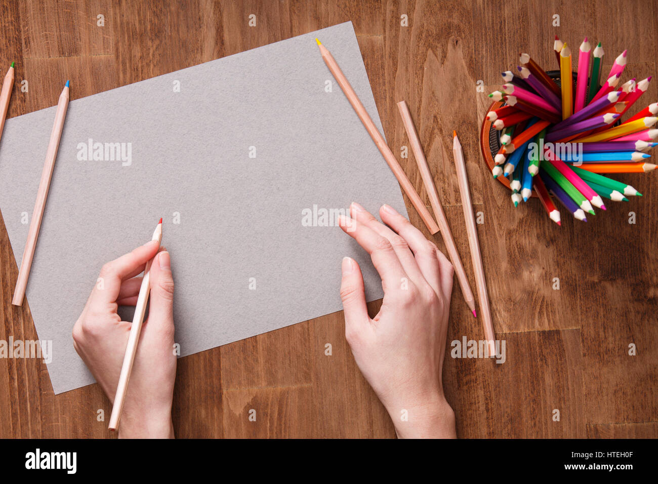 Girl hands drawing, blank yellow paper and colorful pencils on old ...