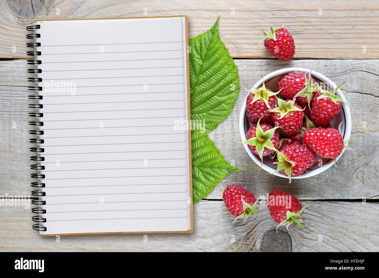 Raspberry and recipe book on wooden table top view Stock Photo - Alamy