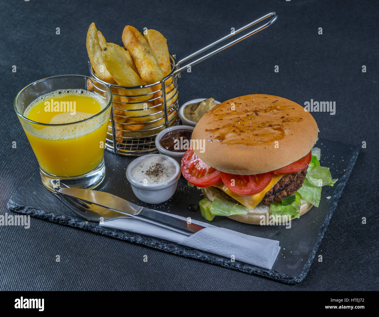 right side view on a flame grilled double stack cheeseburger, lettuce ...