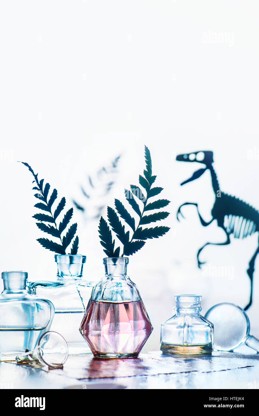 High key still life with collection of perfume bottles and a silhouette ...