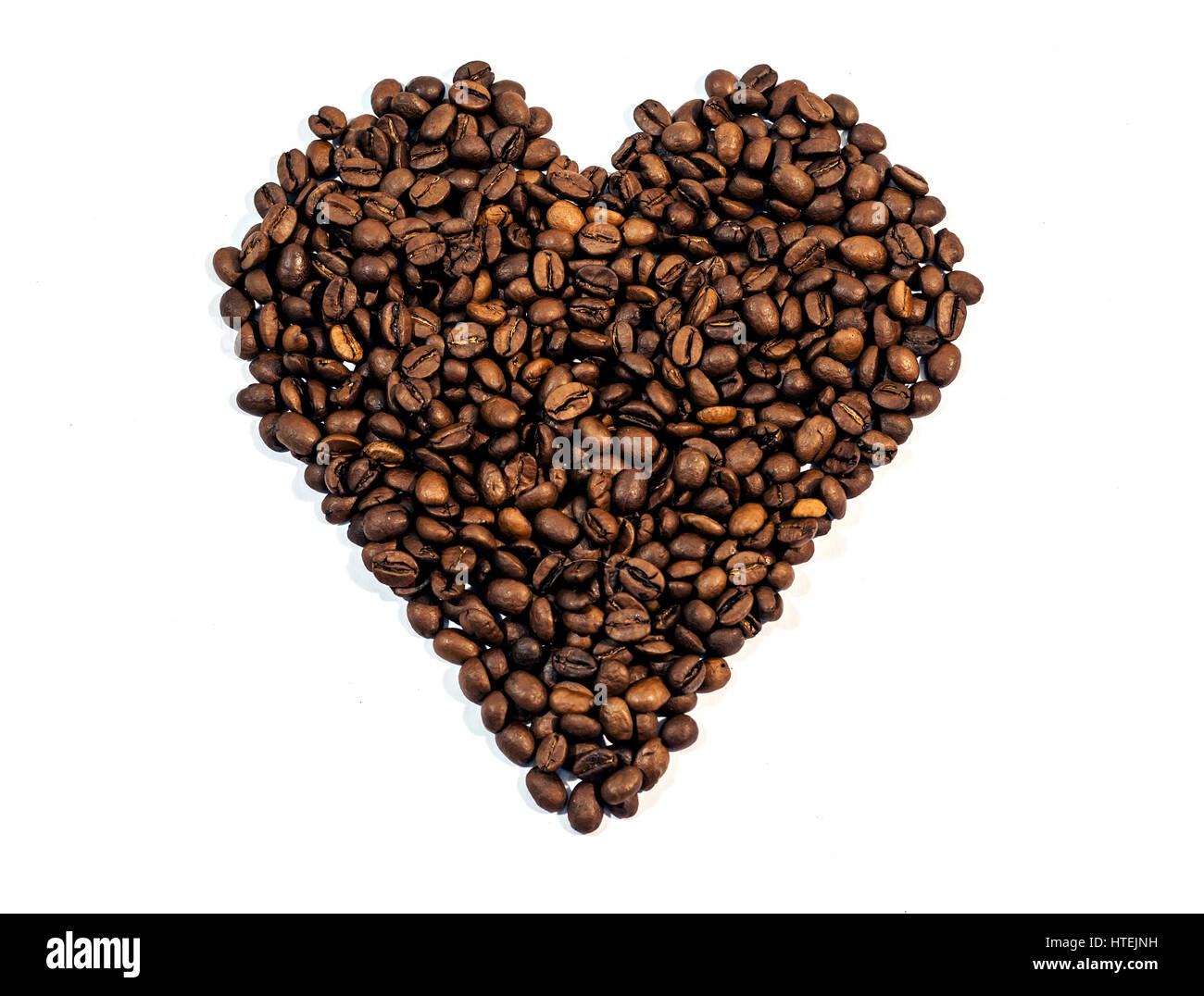 Coffee beans in heart shape with line around heart on white background ...