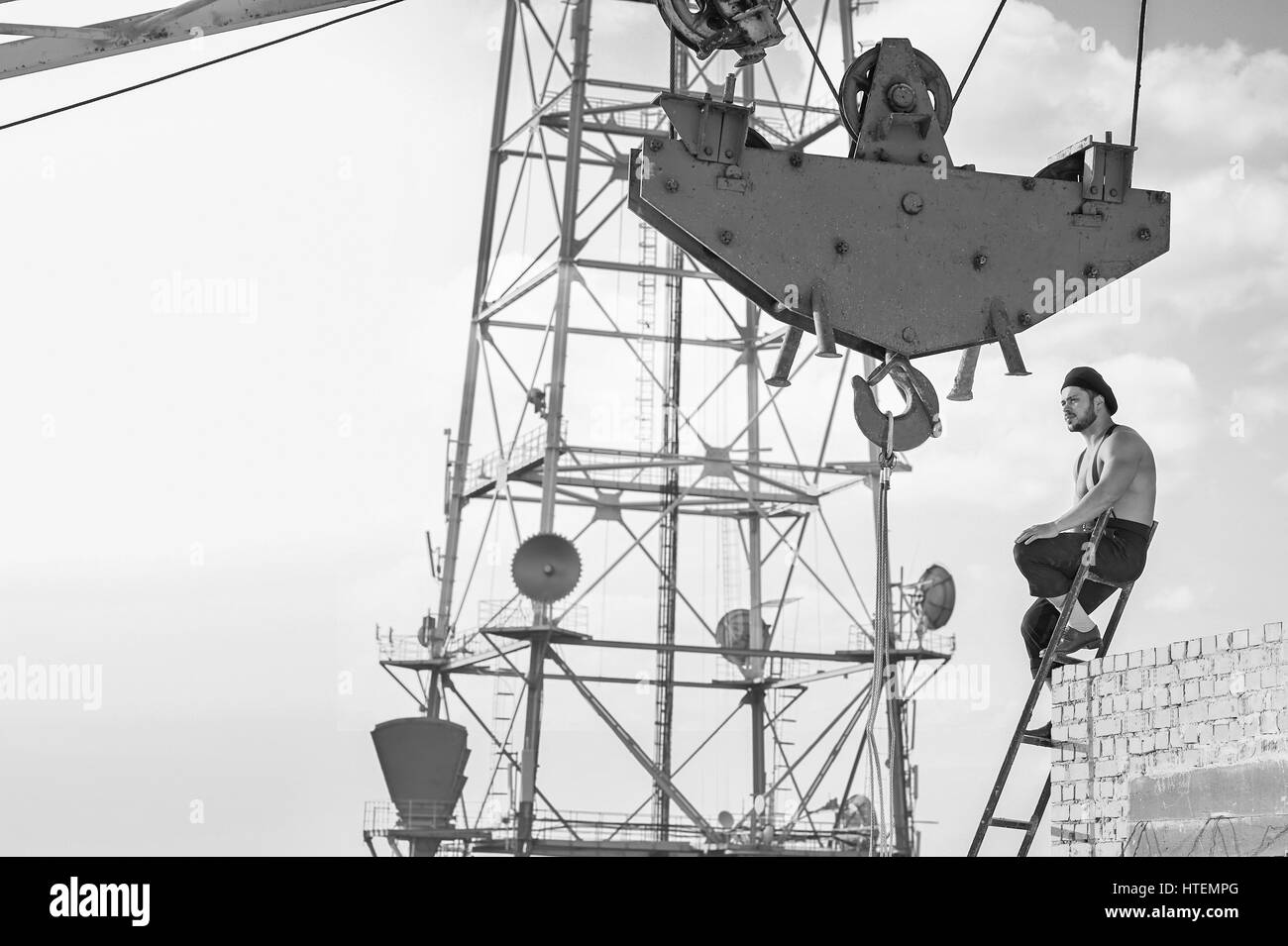 Old fashioned builder. Thoughtful retro styled handy man resting on top ...