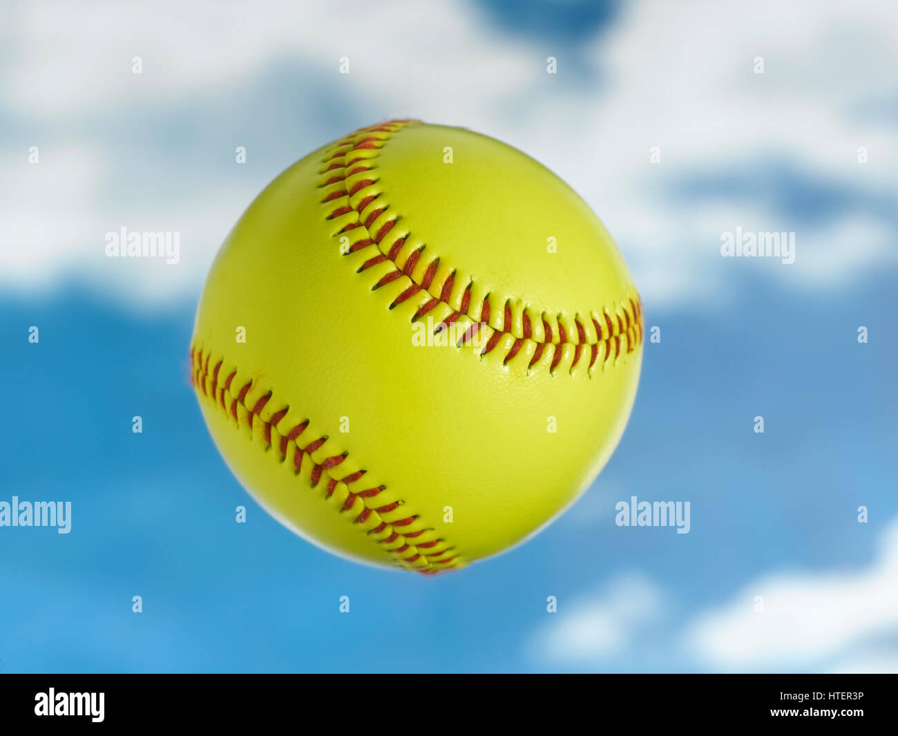 Softball flying thru the sky Stock Photo - Alamy
