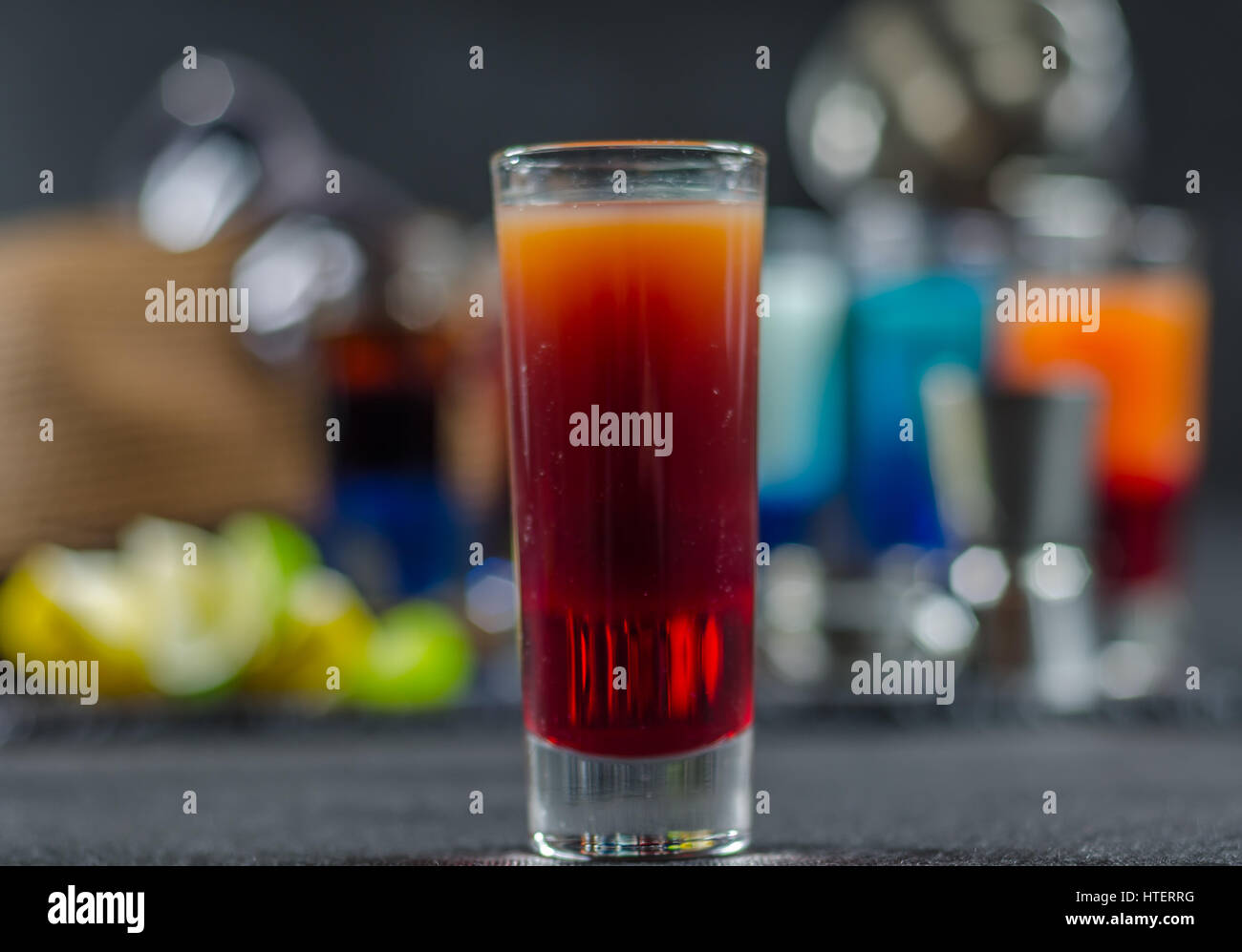 colored drink in glass for shots, a combination of orange with red ...