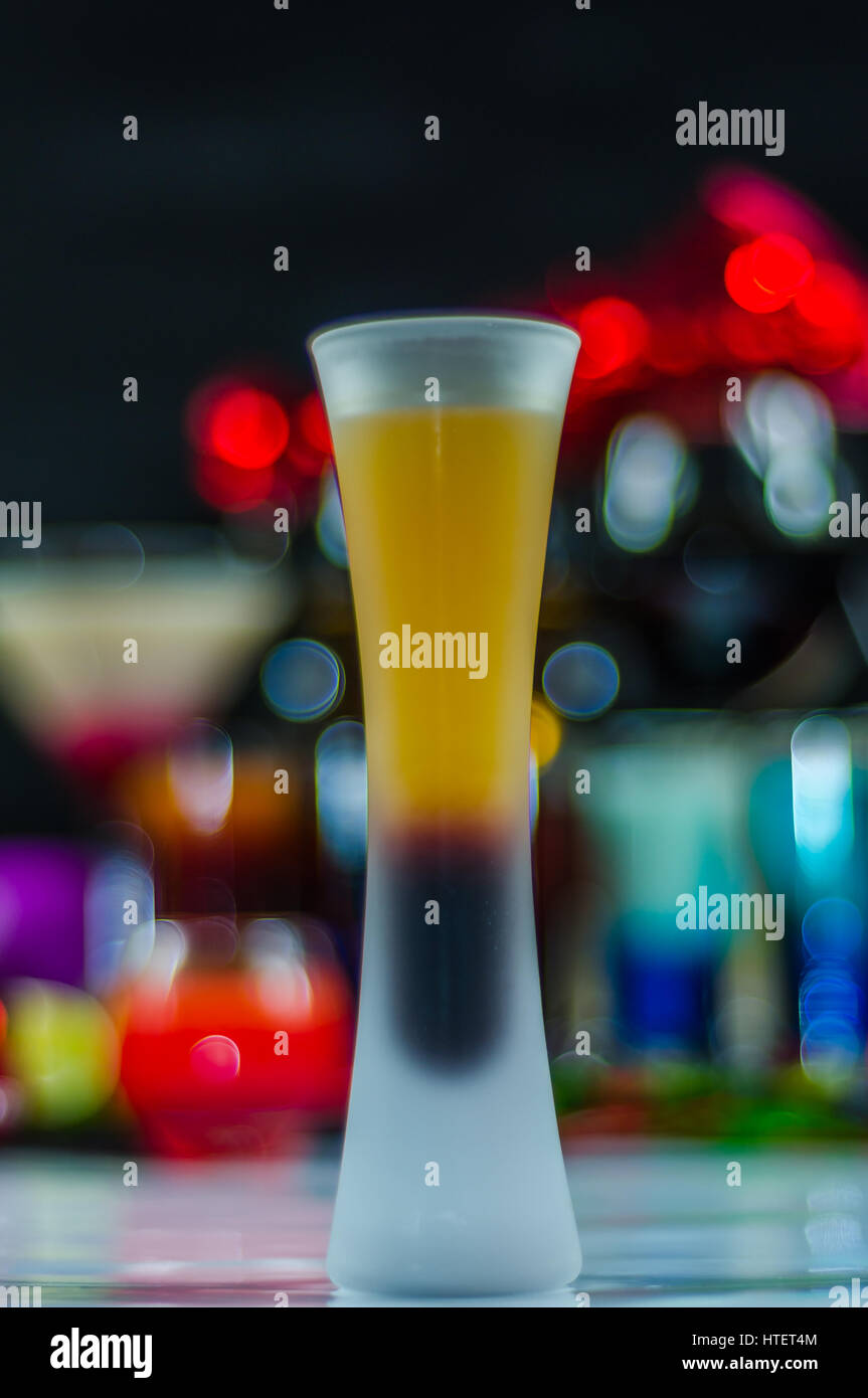 colored drink in glass for shots, a combination of yellow with brown ...