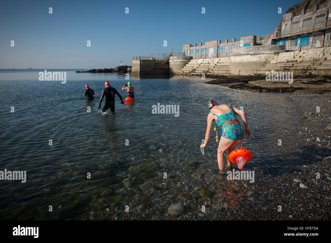 Plymouth, Devon, UK. 21st March 2016. Sea swimmers go for a swim in ...